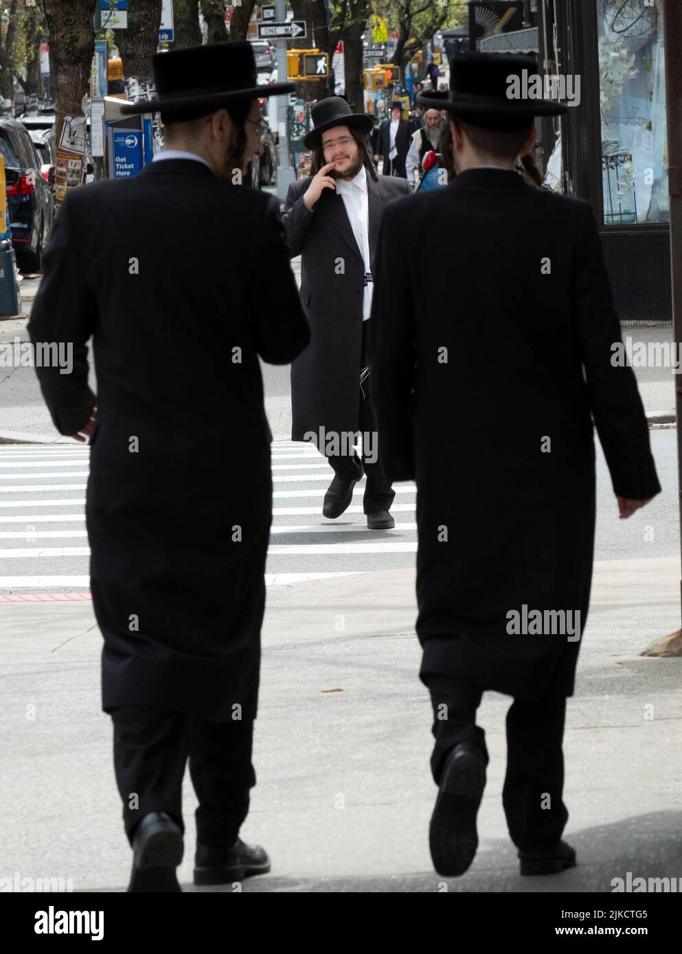 An unusual view of a Hasidic orthodox Jewish man walking on Lee Avenue ...