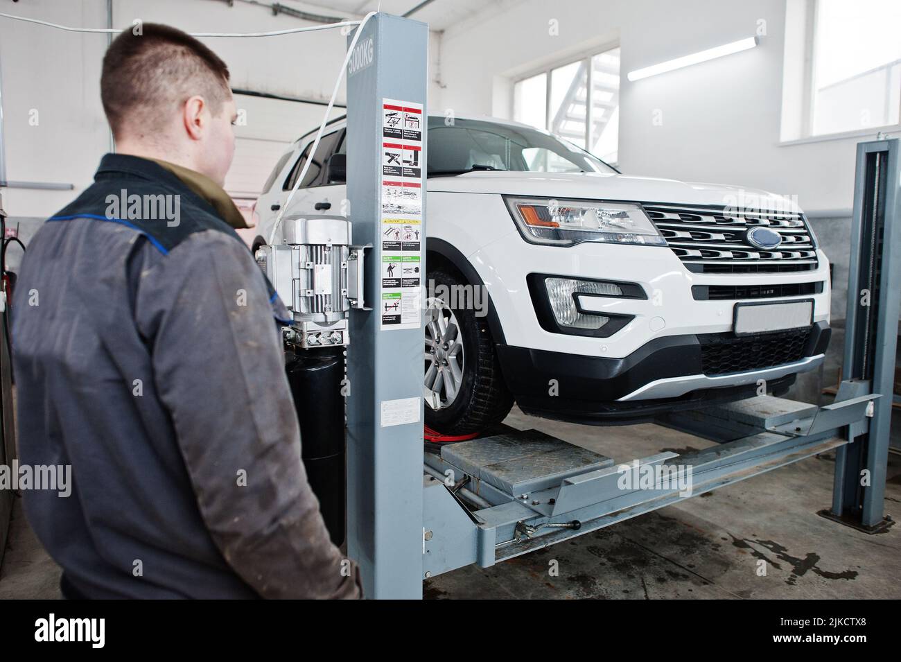 Auto mechanic sets american SUV car for diagnostics and configuration ...