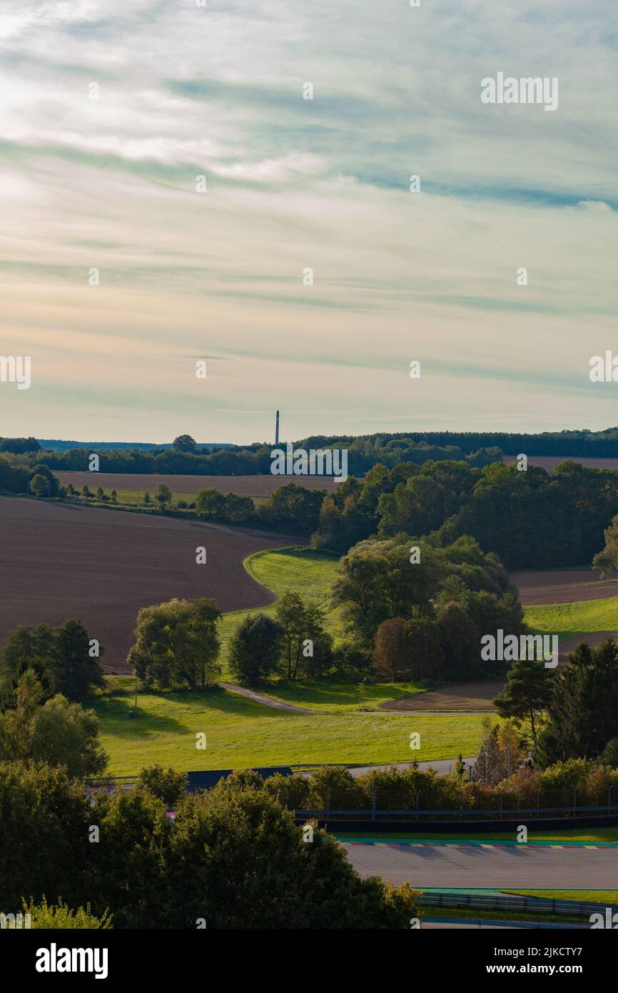 A vertical shot of a road verge with trees in rural area Stock Photo ...