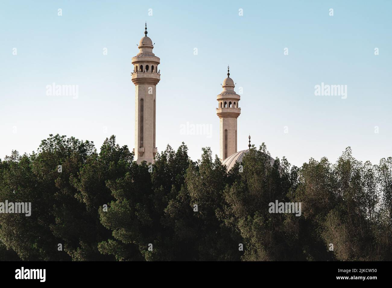 The tall towers of Al Fateh Grand Mosque in Manama, Bahrain behind ...