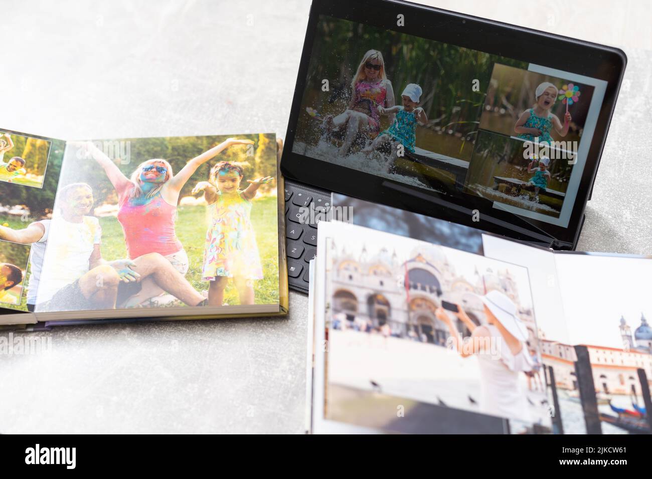 photobook album and tablet on the table Stock Photo - Alamy