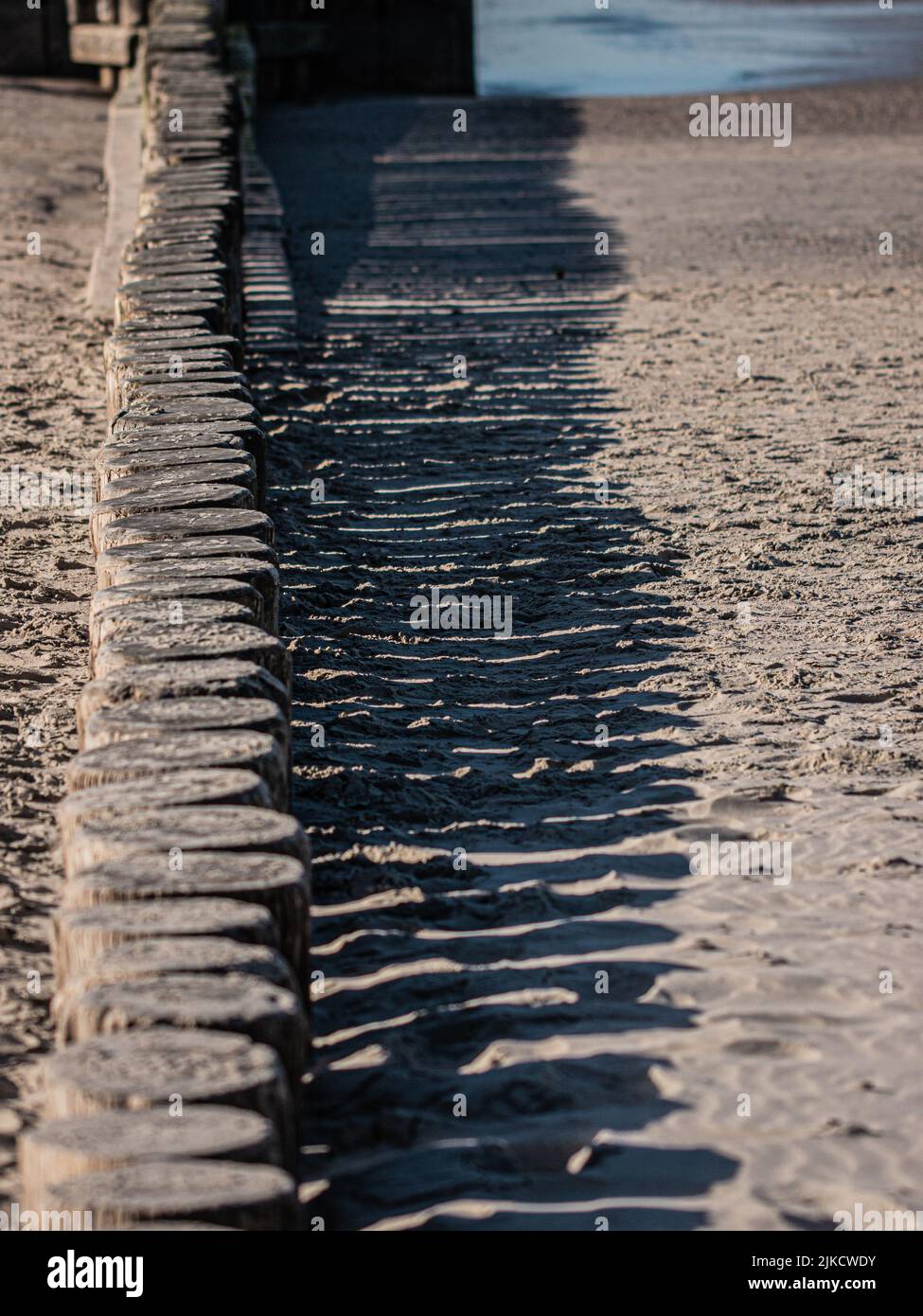 a photo of anti erosion posts hammered into the sand at the beach Stock ...