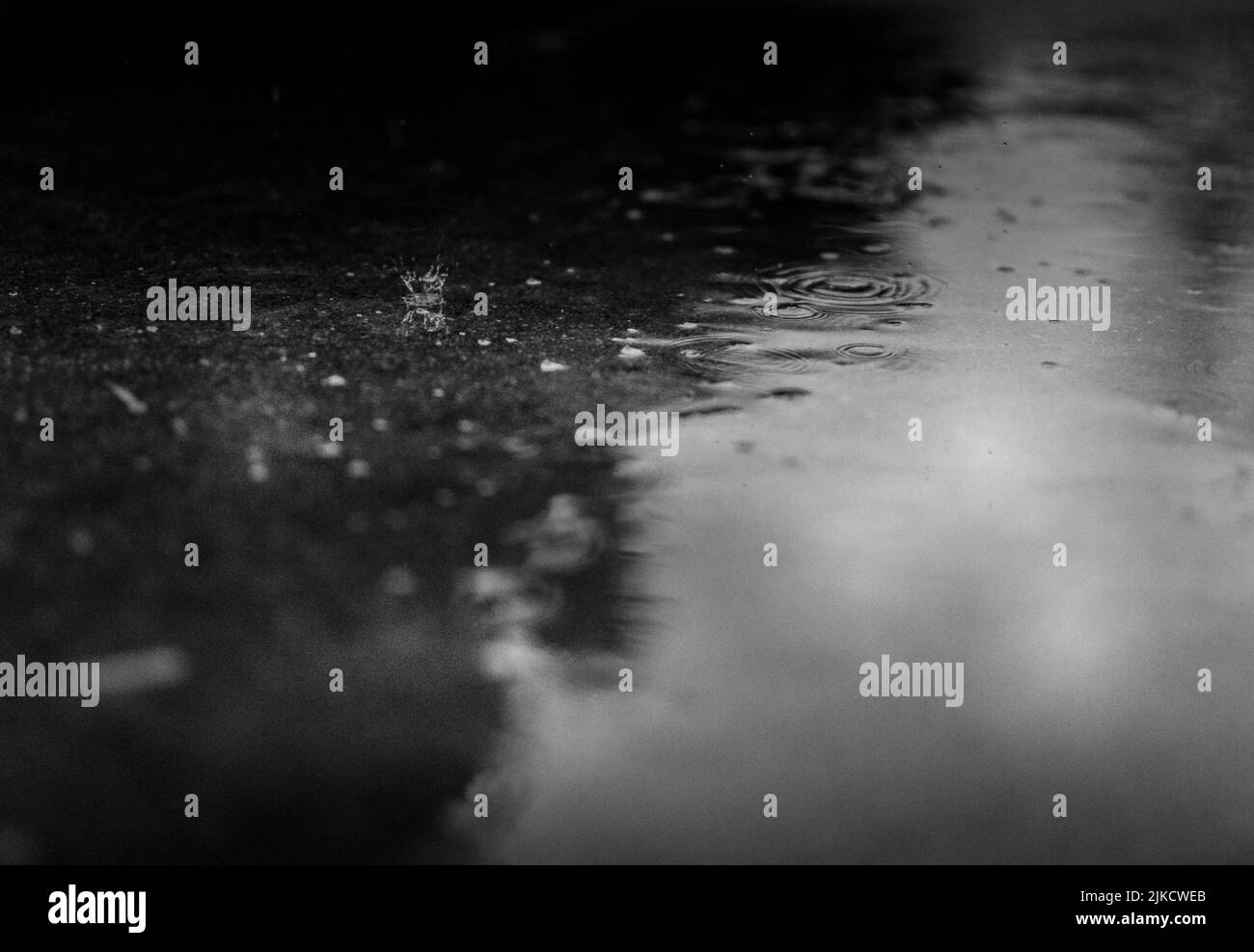 A small raindrop splashing on concrete during a rainstorm Stock Photo ...