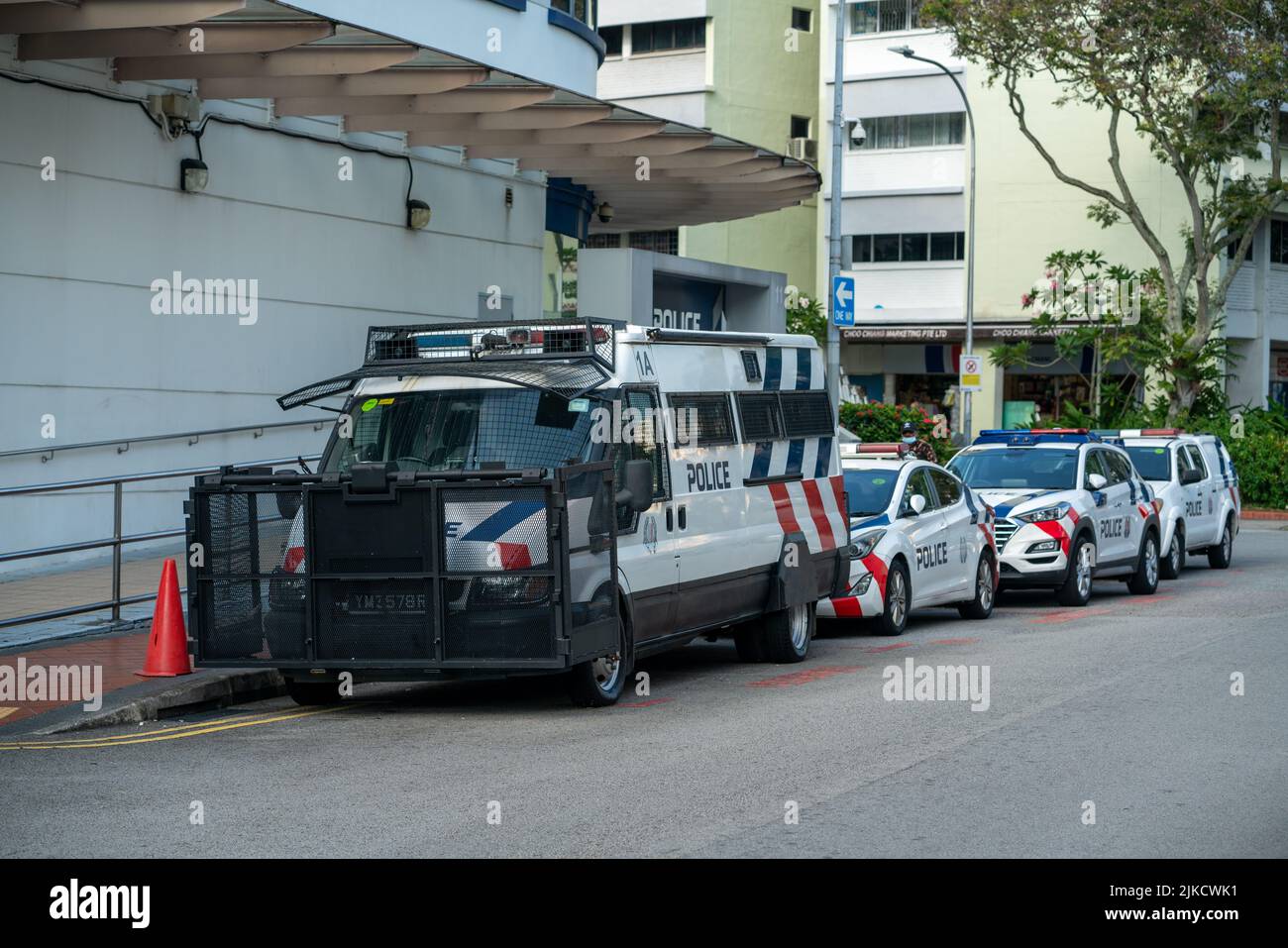 Armoured truck and police cars parked at police station. Horizontal ...