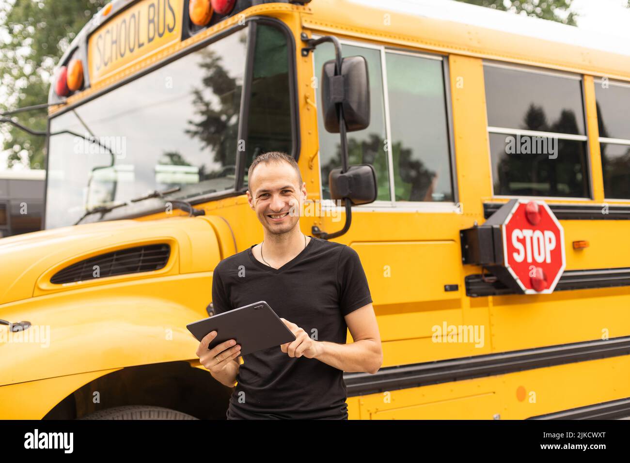 male teacher near school bus Stock Photo - Alamy