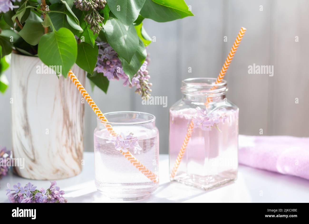 lilac refreshing drink, selective focus. bouquet of lilacs and a purple ...