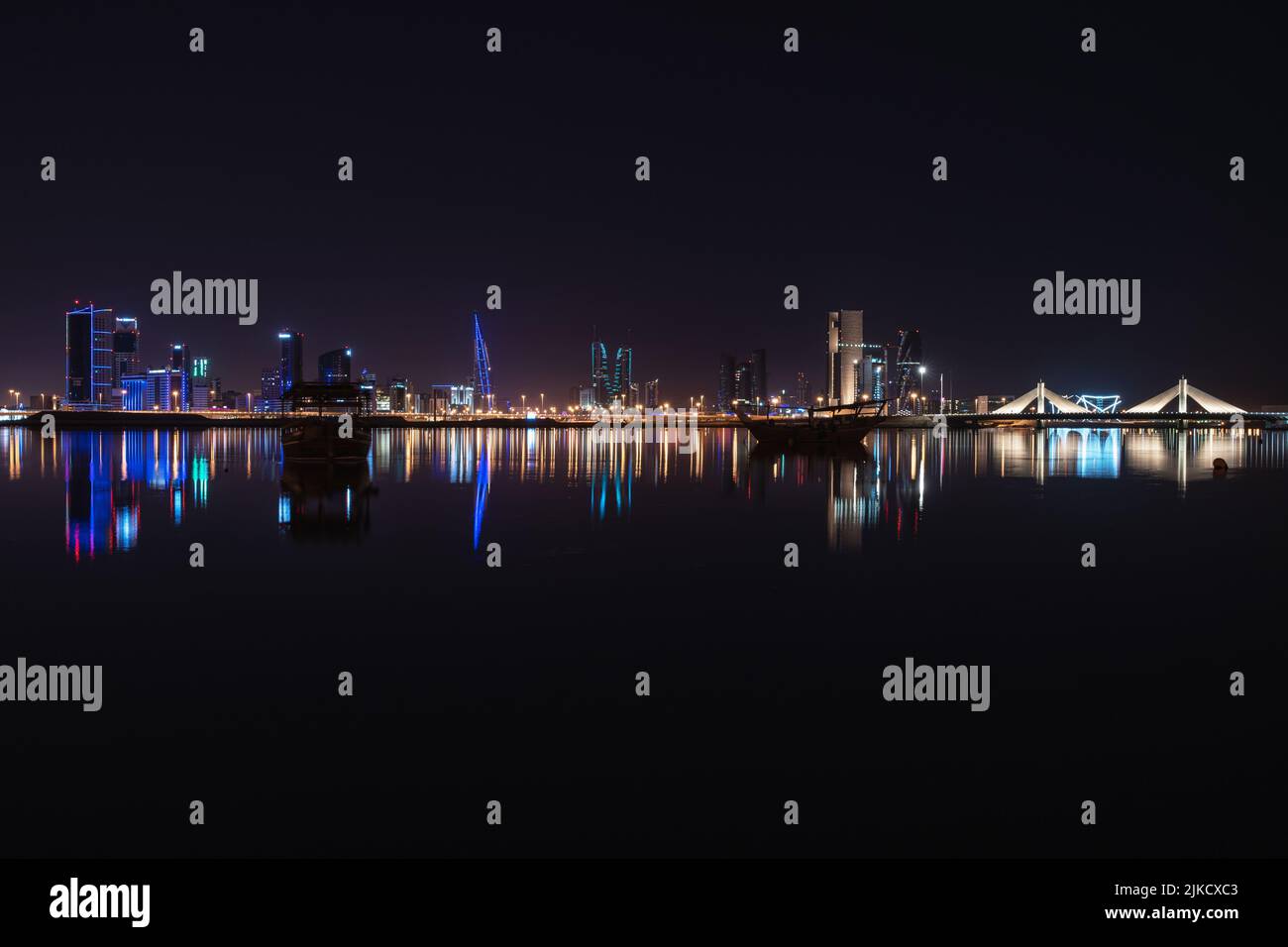 The illuminated Manama skyline from the water at night in Bahrain Stock ...