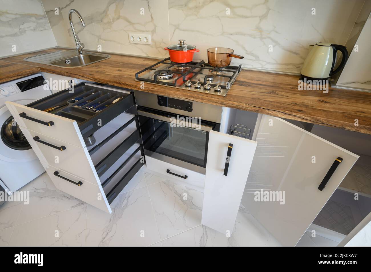 White and wooden modern kitchen furniture, some drawers open Stock ...