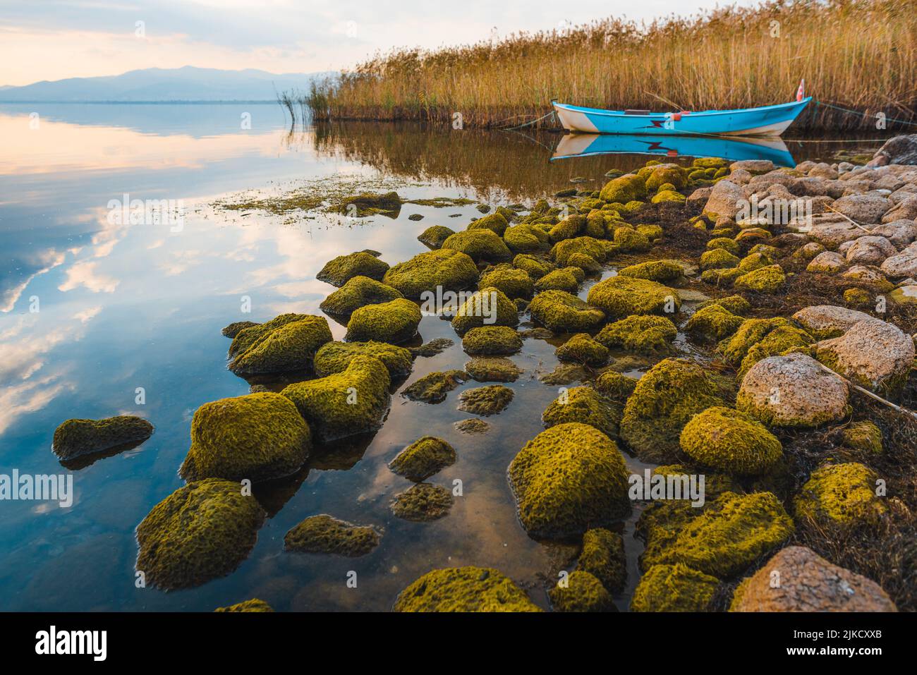 lake view, fishing boat on the lake shore Stock Photo - Alamy