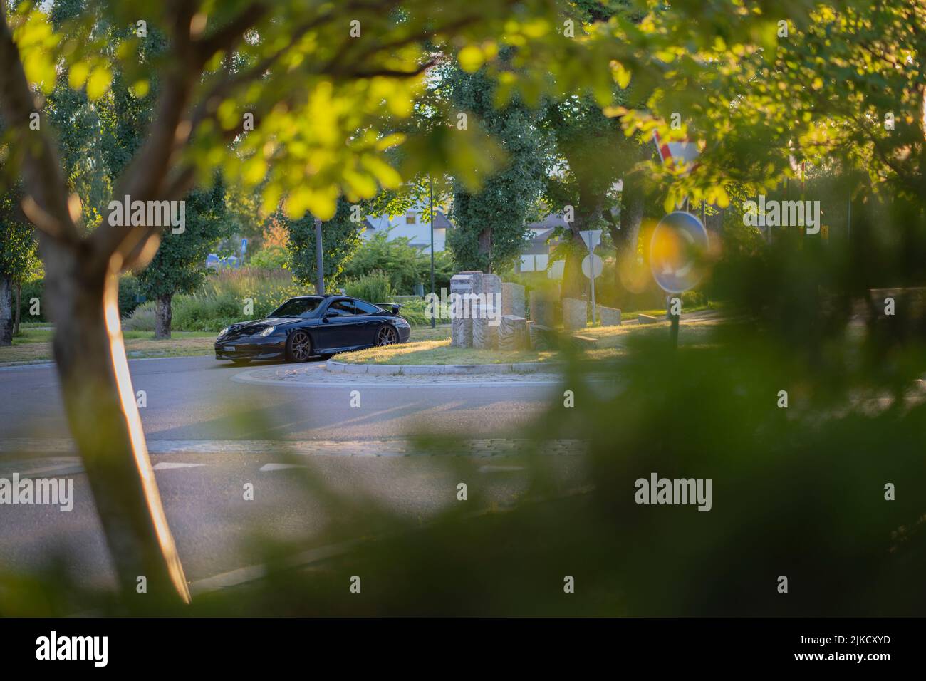 A car in a roundabout during golden hour Stock Photo - Alamy