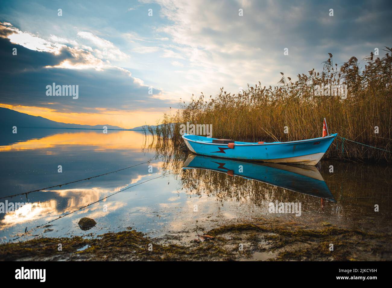lake view, fishing boat on the lake shore Stock Photo - Alamy