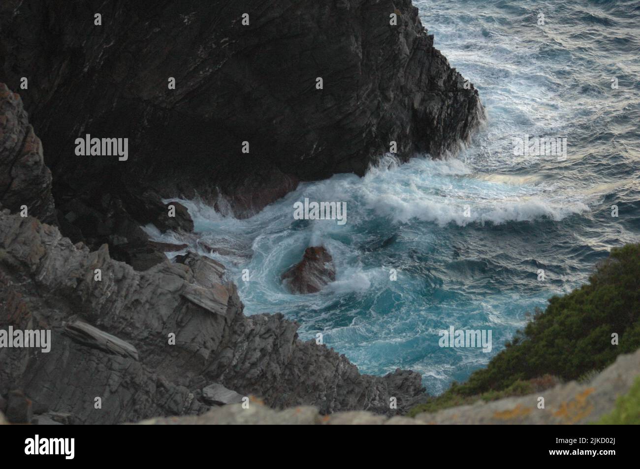 The waves crash against the rocks on the shore Stock Photo - Alamy