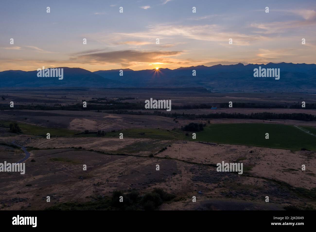 Aerial view of the sun setting behind the Gallatin Mountains near Pray ...