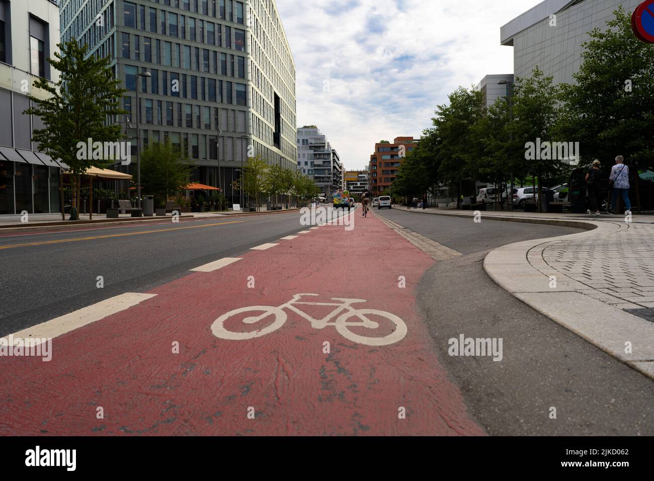 People cycling in the street in front of the opera house Stock Photo ...