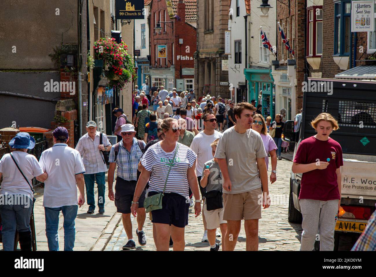 High summer in Whitby and crowds gather in the shopping streets Stock ...