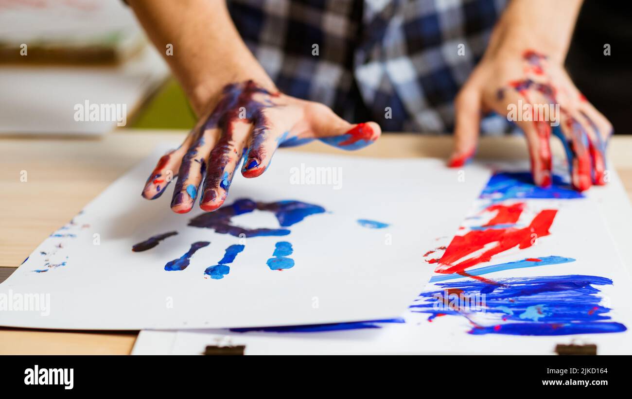 art therapy school paint hand print paper Stock Photo - Alamy