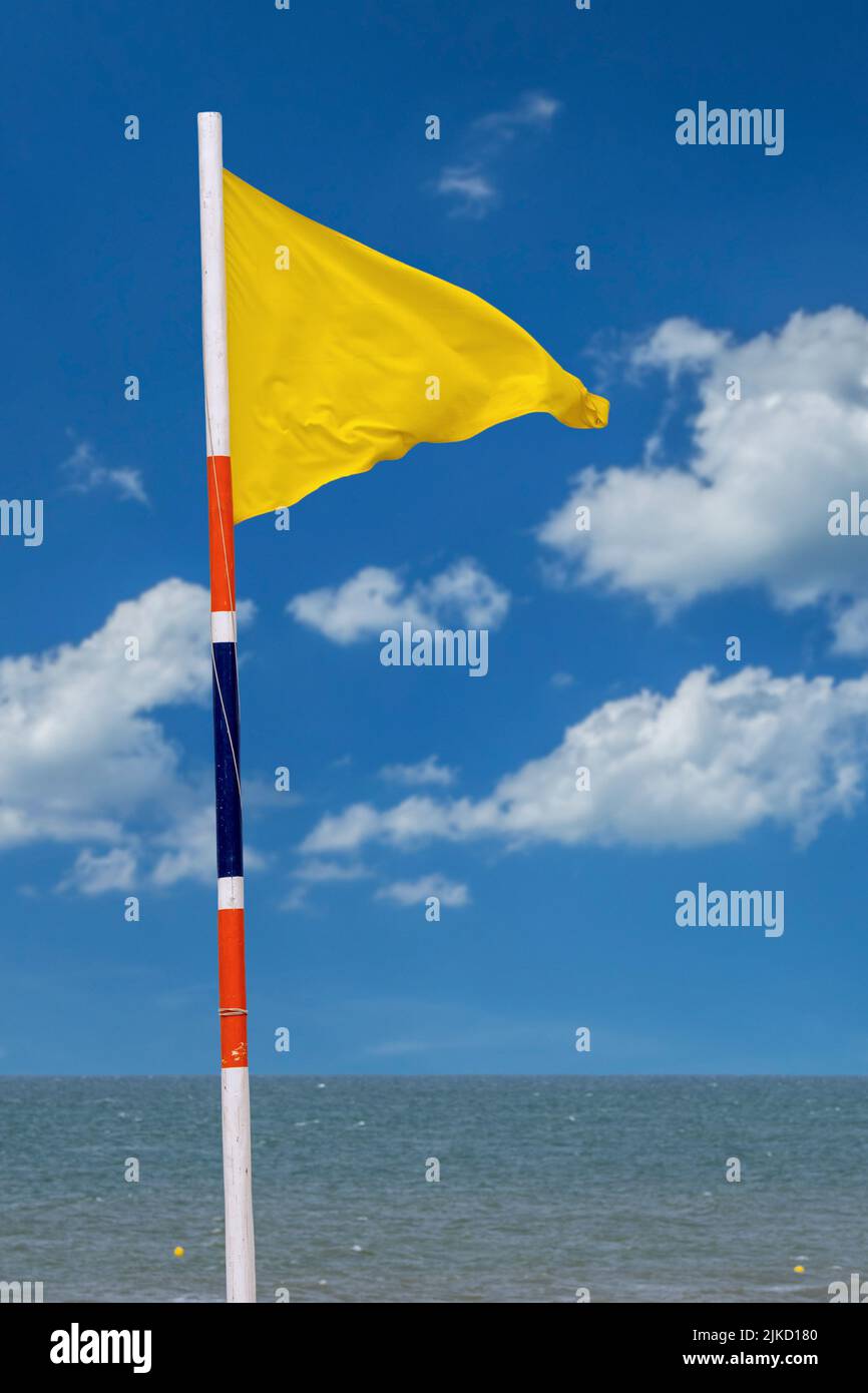 Yellow warning flag signalling medium hazard. Swimming allowed, only ...