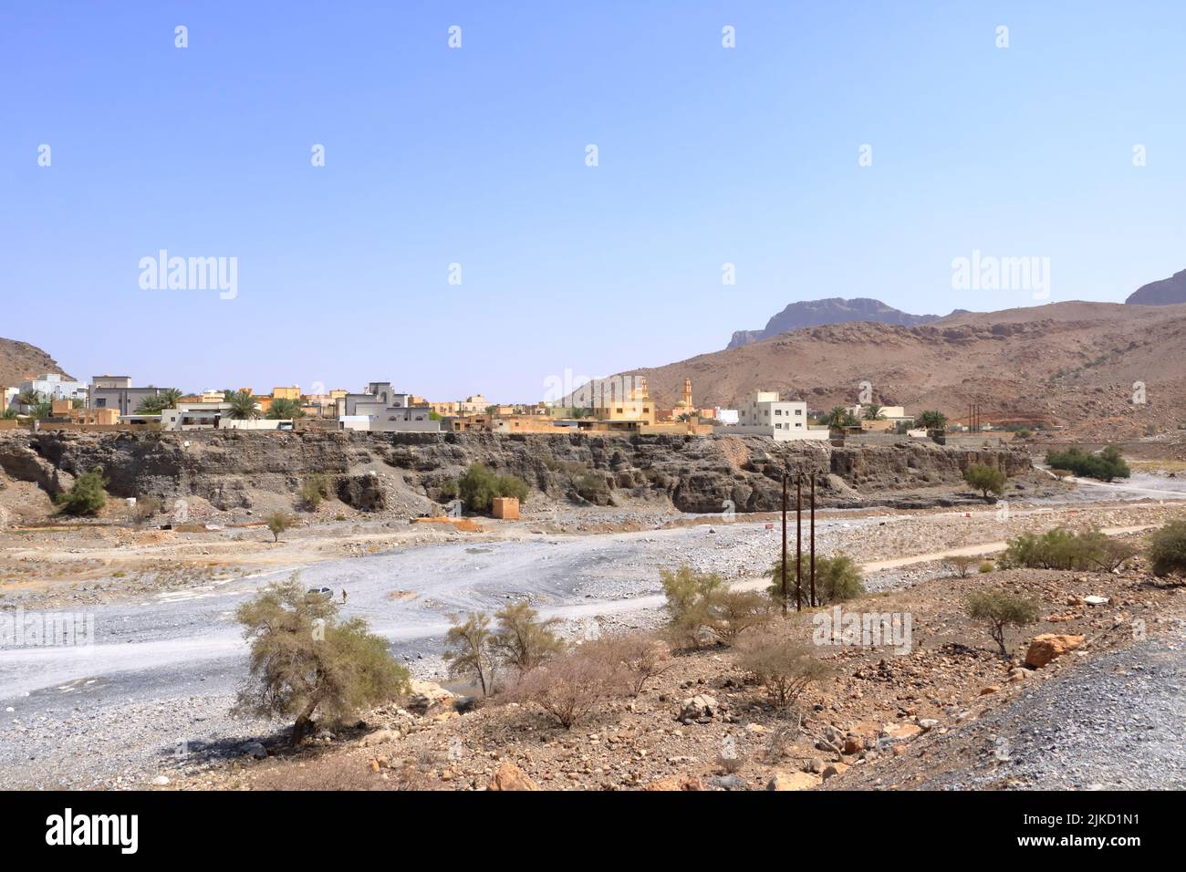 Abandoned village ruins of Riwaygh as-Safil with an oasis underneath on ...