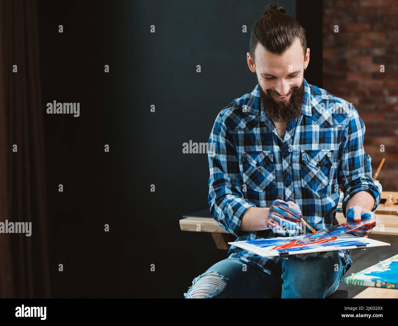 modern workshop enthusiastic young artist painting Stock Photo - Alamy