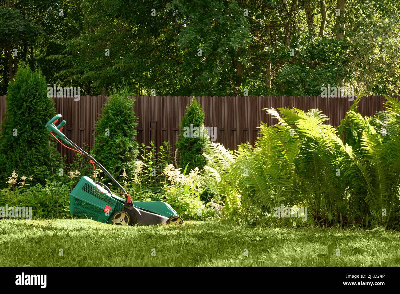 Hand lawnmower during regular mowing of a lawn at summer Stock Photo ...