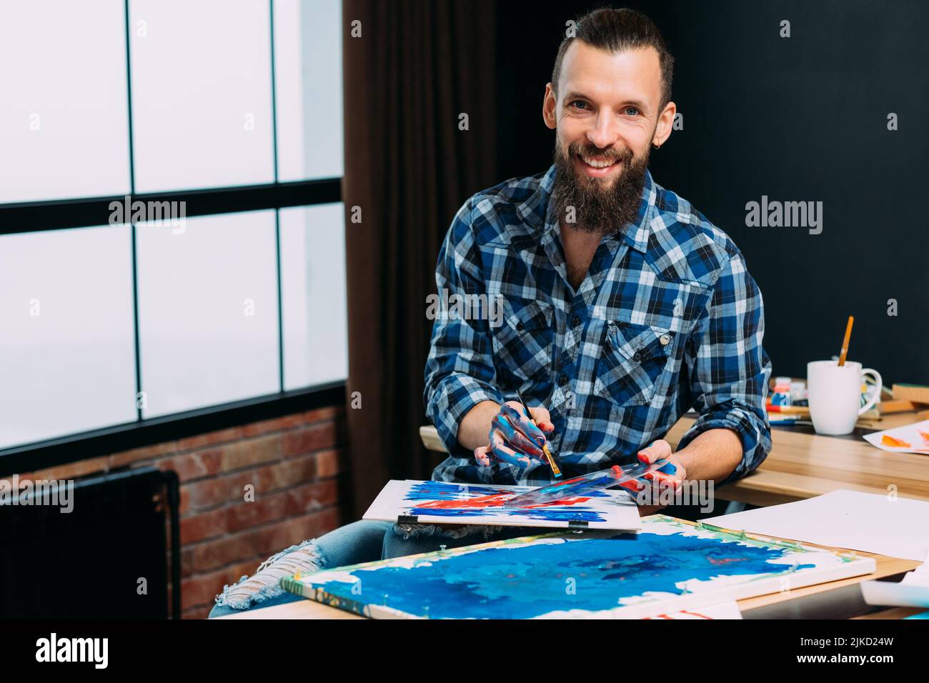 smiling painter artwork artist creating studio Stock Photo - Alamy