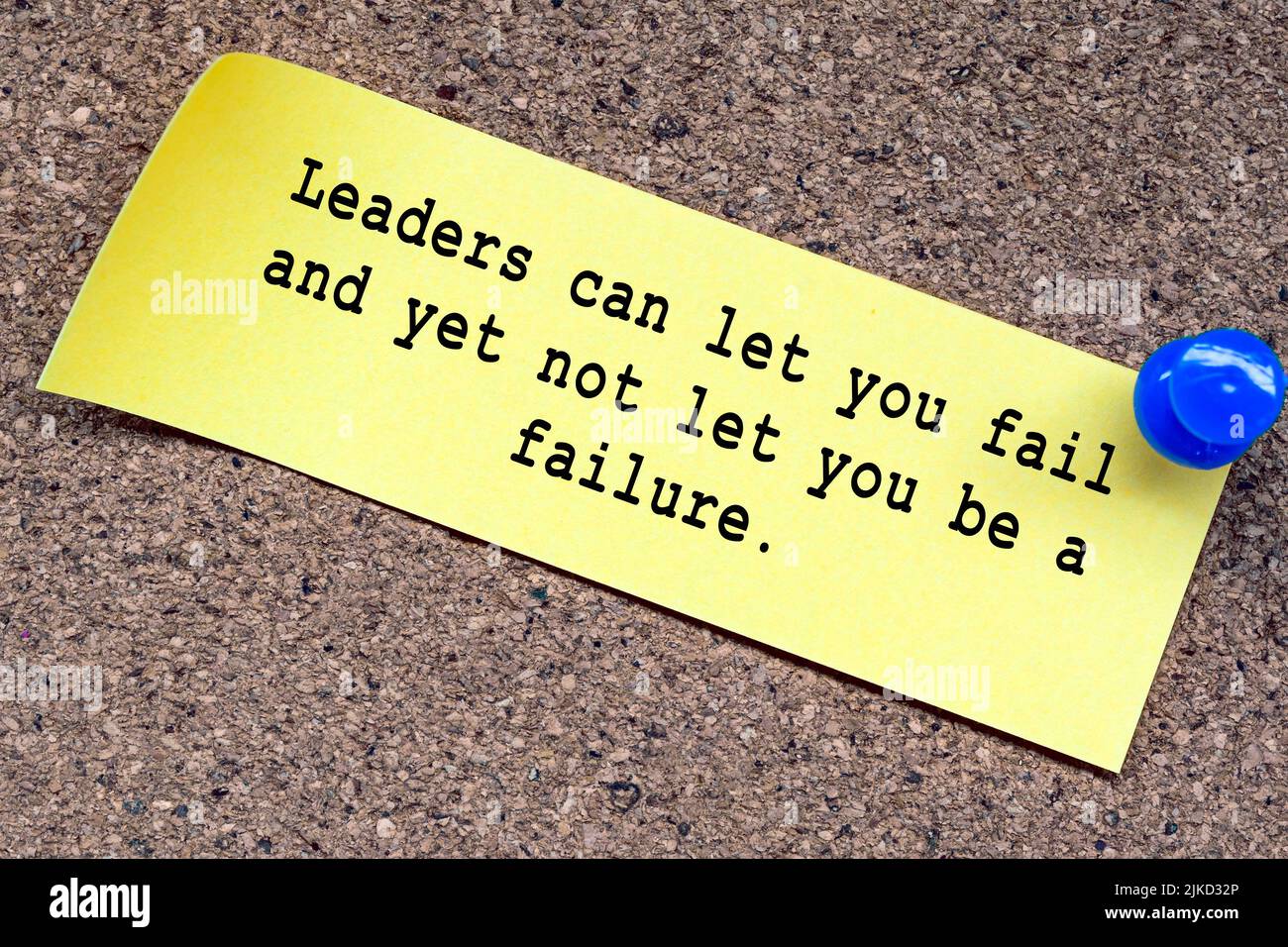 Motivational quote on stick note and pinned to a cork notice board ...