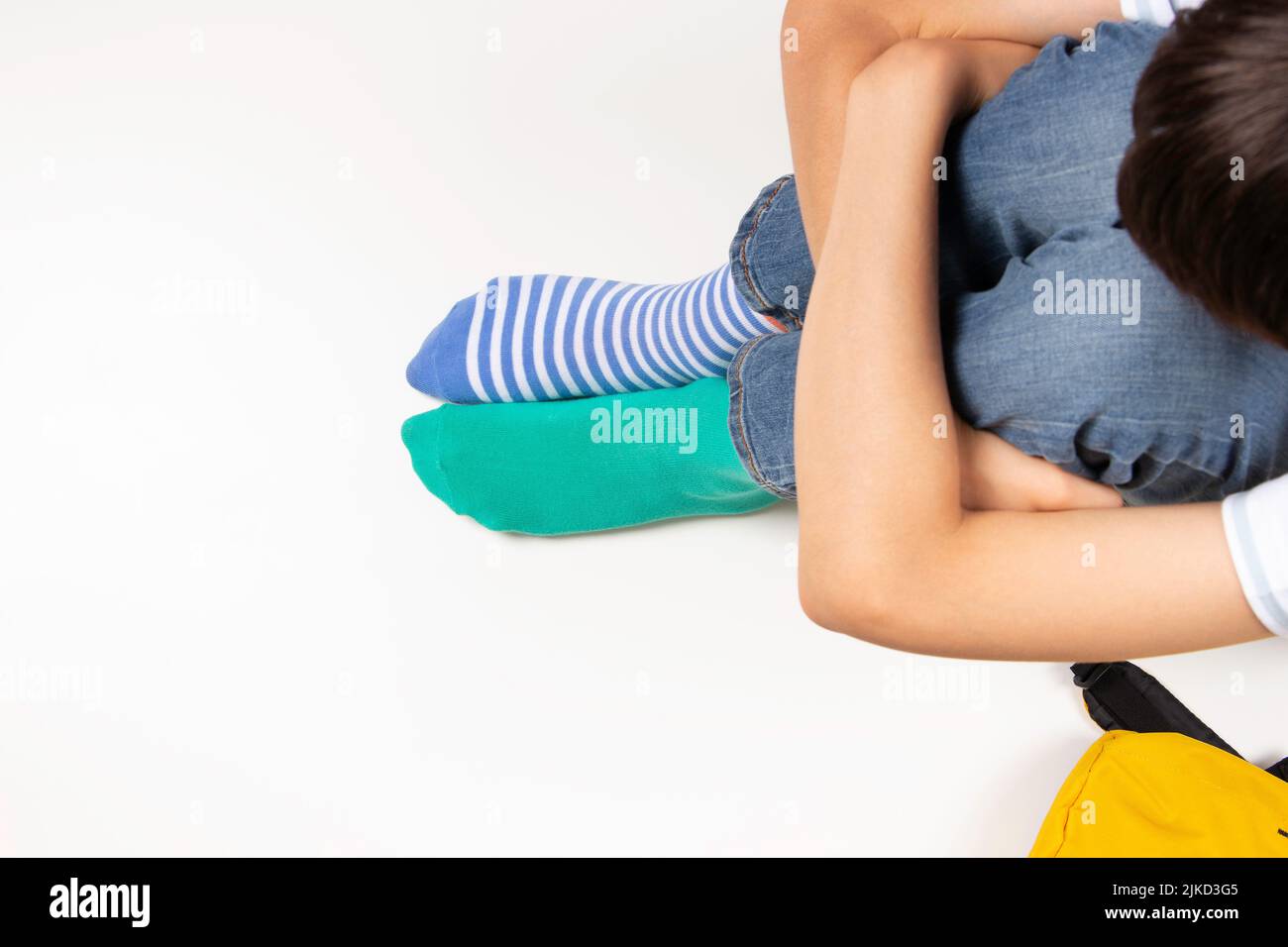 Kid wearing different pair of socks. Child foots in mismatched socks ...