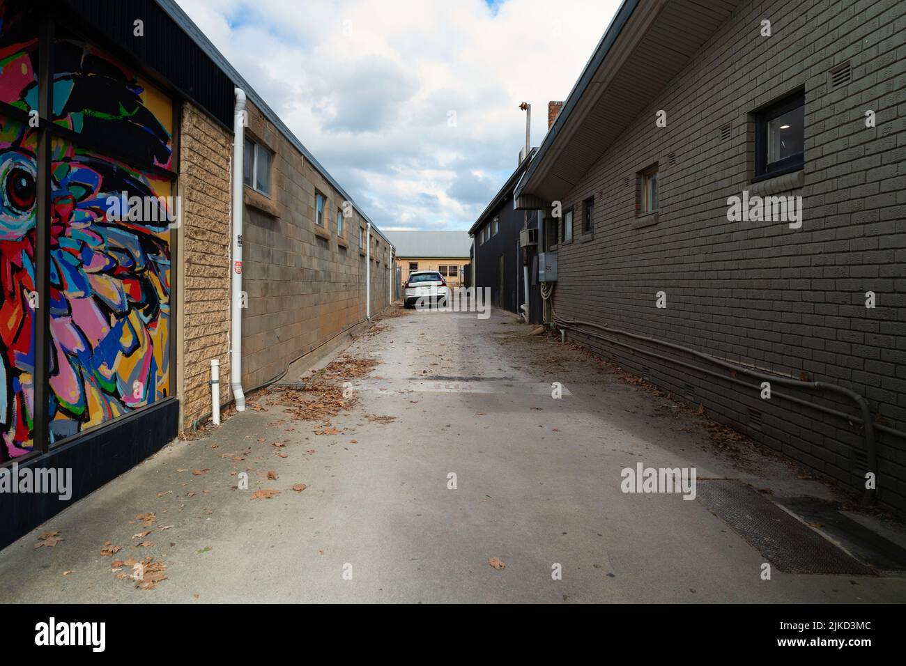 A car parked on a narrow street between two buildings Stock Photo - Alamy