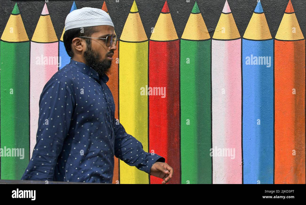 Mumbai, India. 01st Aug, 2022. A Muslim man walks past a colour pencil ...