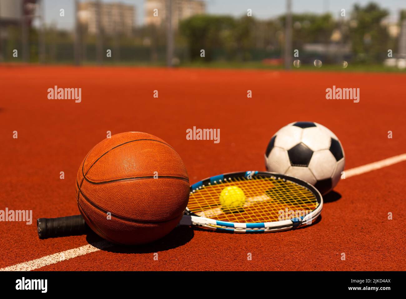 Sport games equipment - balls, rackets - on court Stock Photo - Alamy