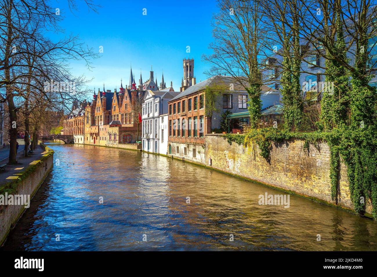 Historic medieval buildings along a canal in Bruges, Belgium Stock ...