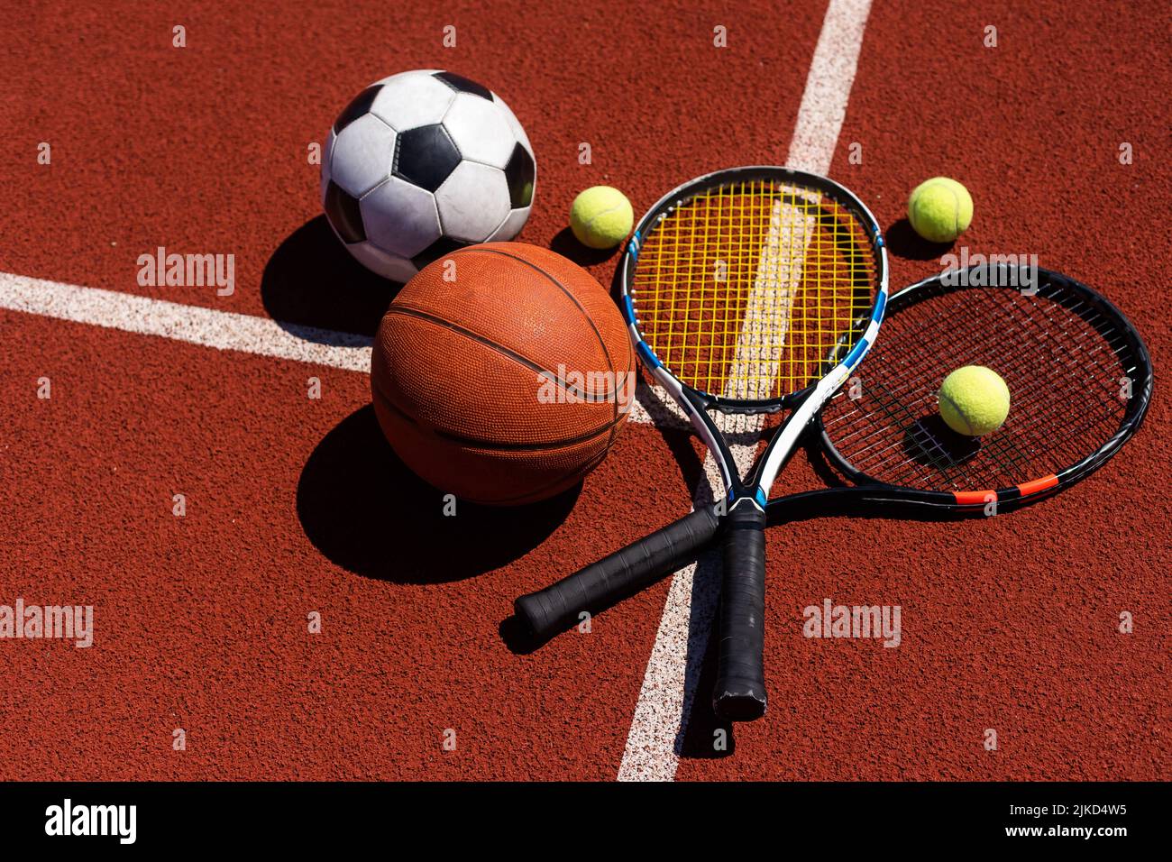 Sport games equipment - balls, rackets - on court Stock Photo - Alamy