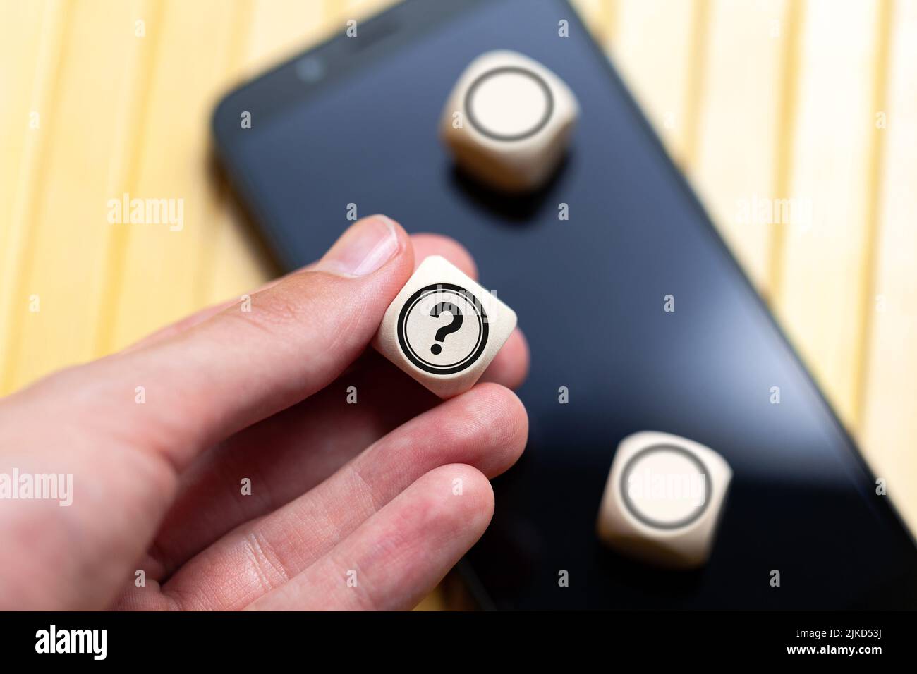 Simple question mark cube abstract object near a smartphone, mobile ...