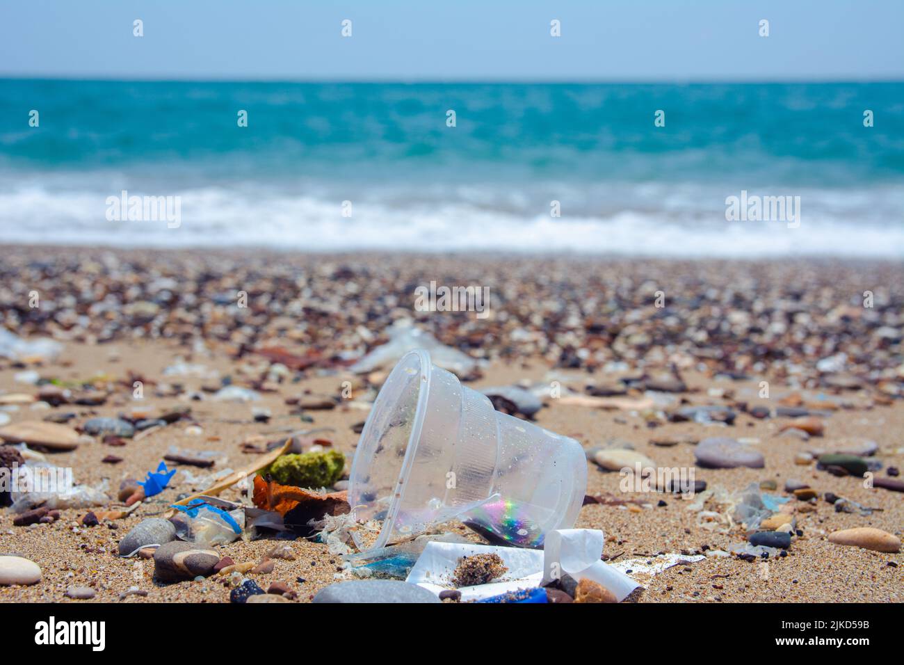 Garbage on the sea beach. A man-made garbage in the sea: plastic ...
