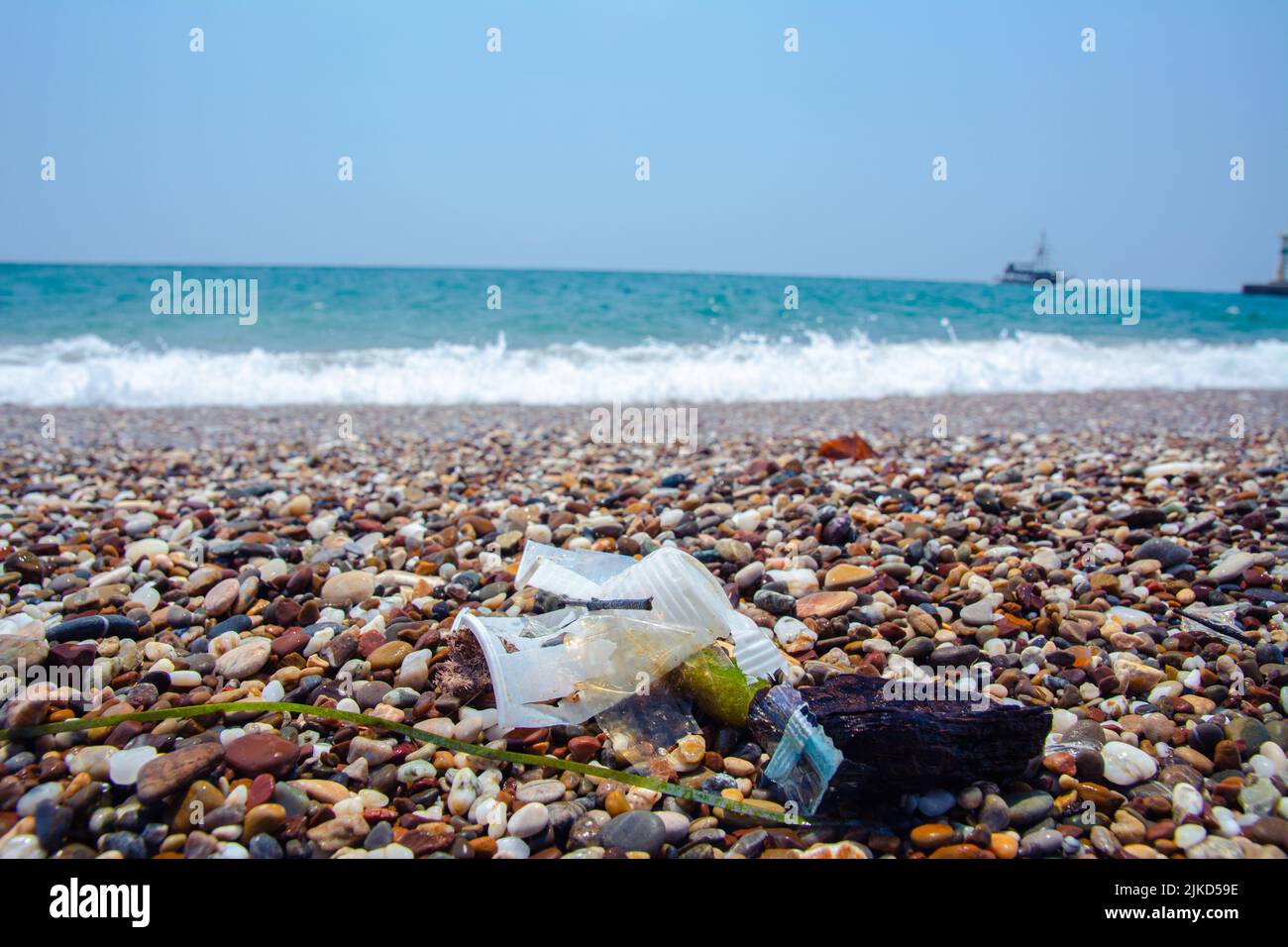 Garbage on the sea beach. A man-made garbage in the sea: plastic ...