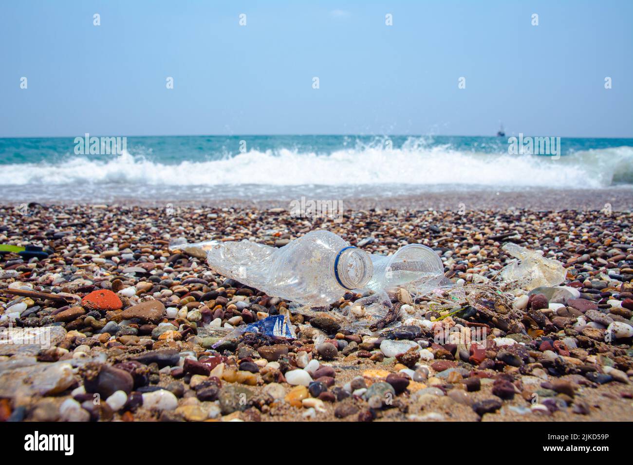 Garbage on the sea beach. A man-made garbage in the sea: plastic ...