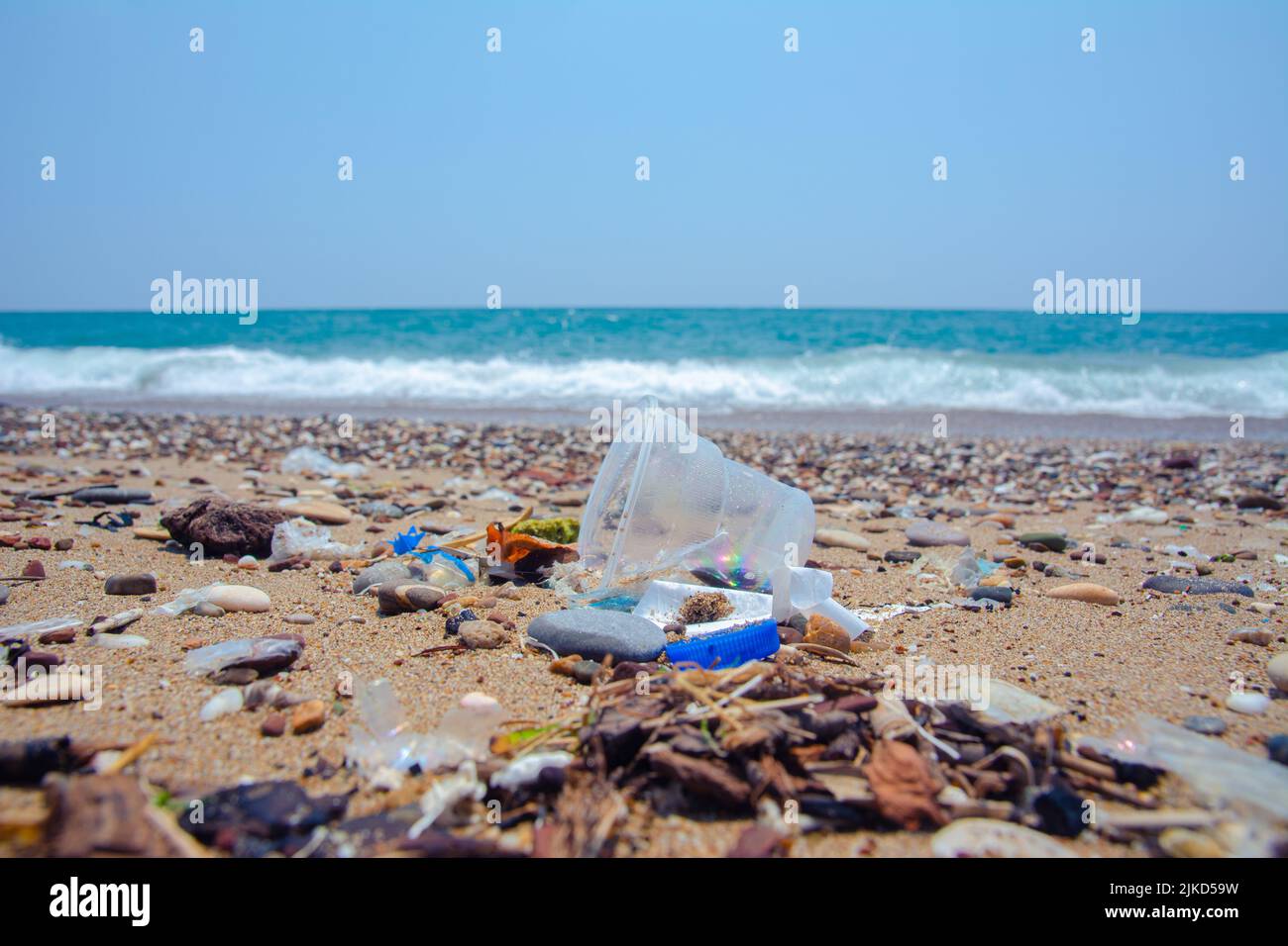 Garbage on the sea beach. A man-made garbage in the sea: plastic ...