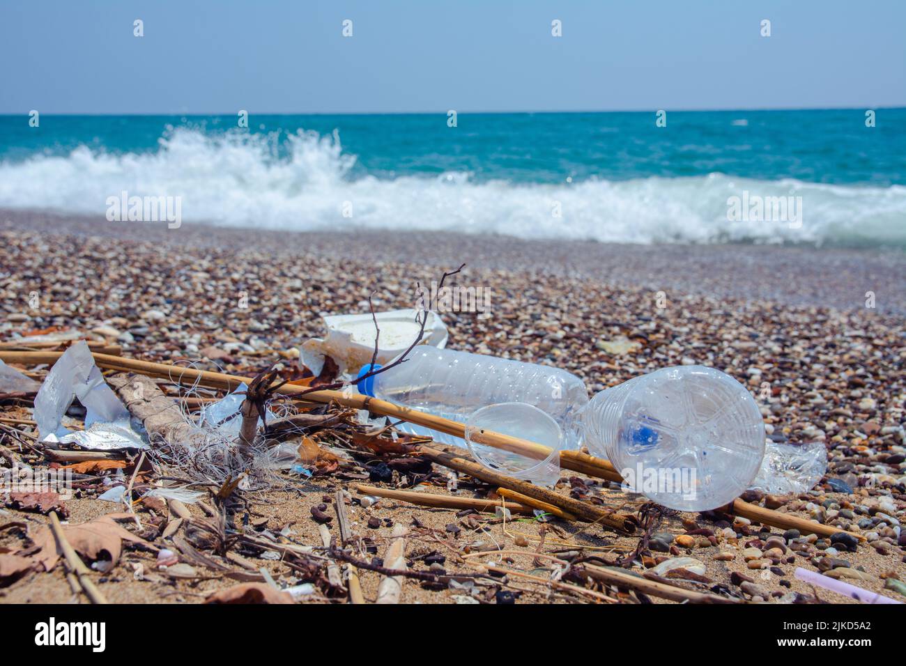 Garbage on the sea beach. A man-made garbage in the sea: plastic ...