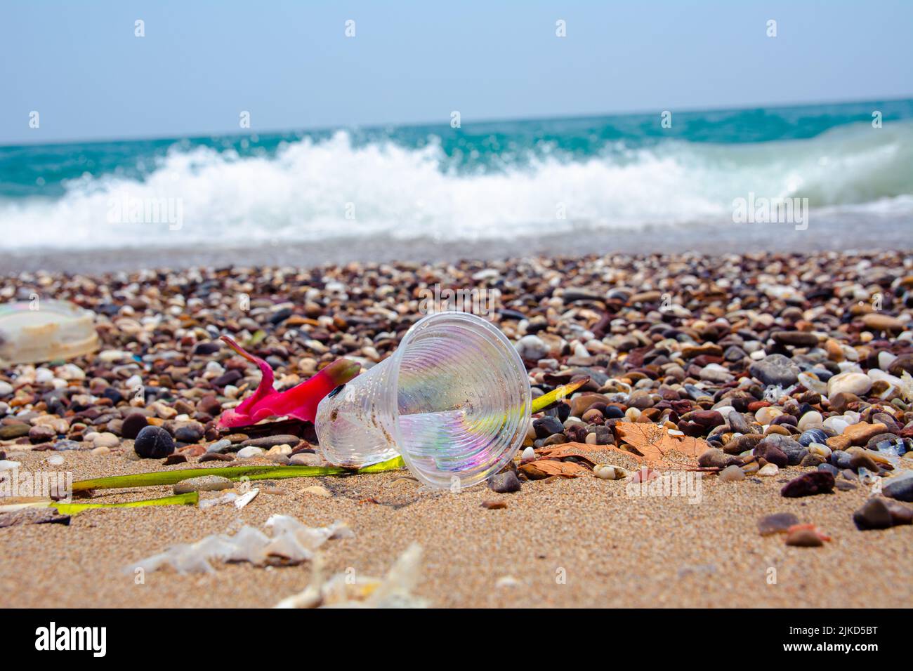 Garbage on the sea beach. A man-made garbage in the sea: plastic ...