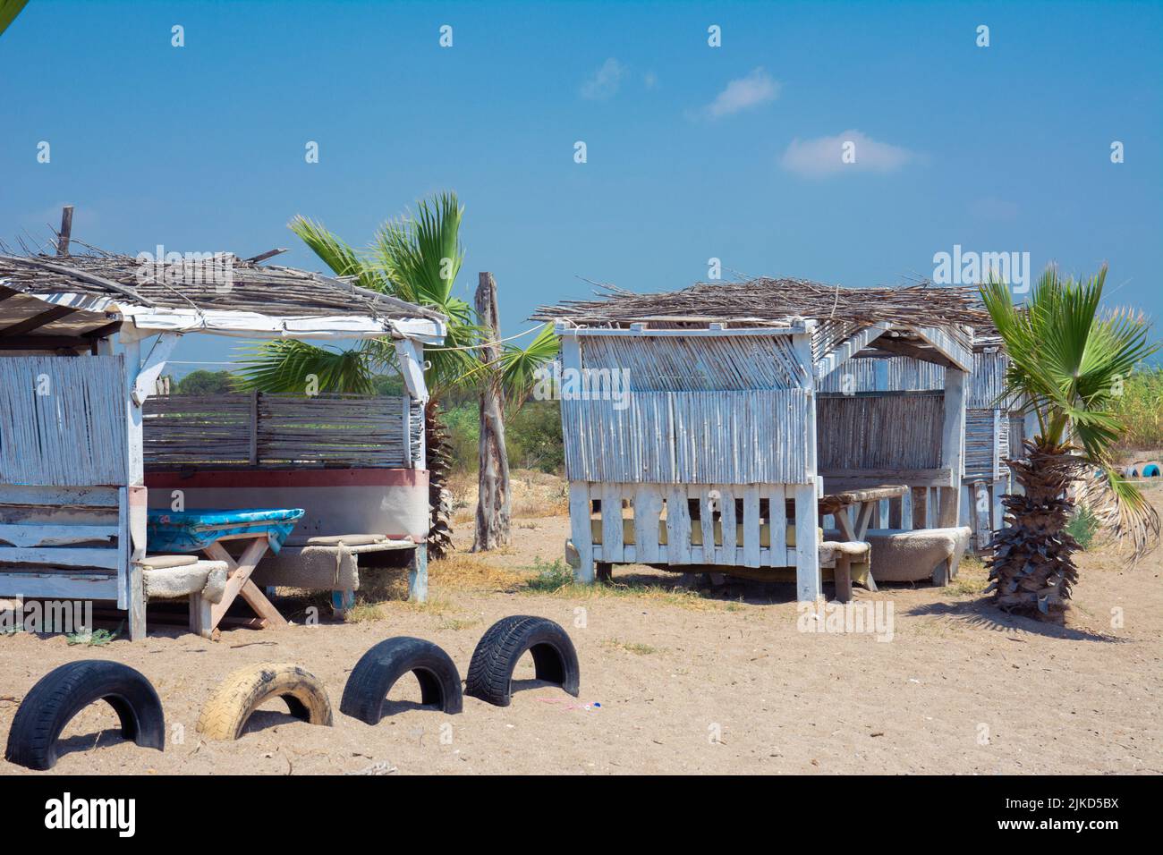 An old beach cafe with wooden houses painted white. Vintage Turkish ...
