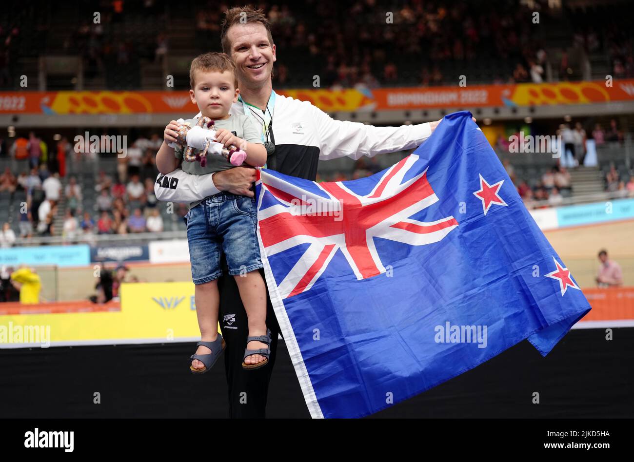 New Zealand's Aaron Gate celebrates with the gold medal and son Axel ...