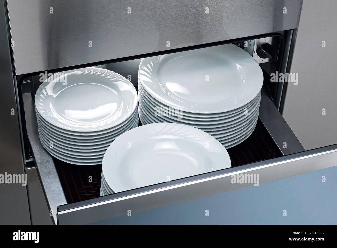 Stack of plates in the drawer Stock Photo - Alamy