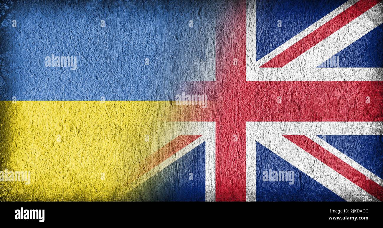 Ukrainian and United Kingdom flag on concrete, divided in the middle ...