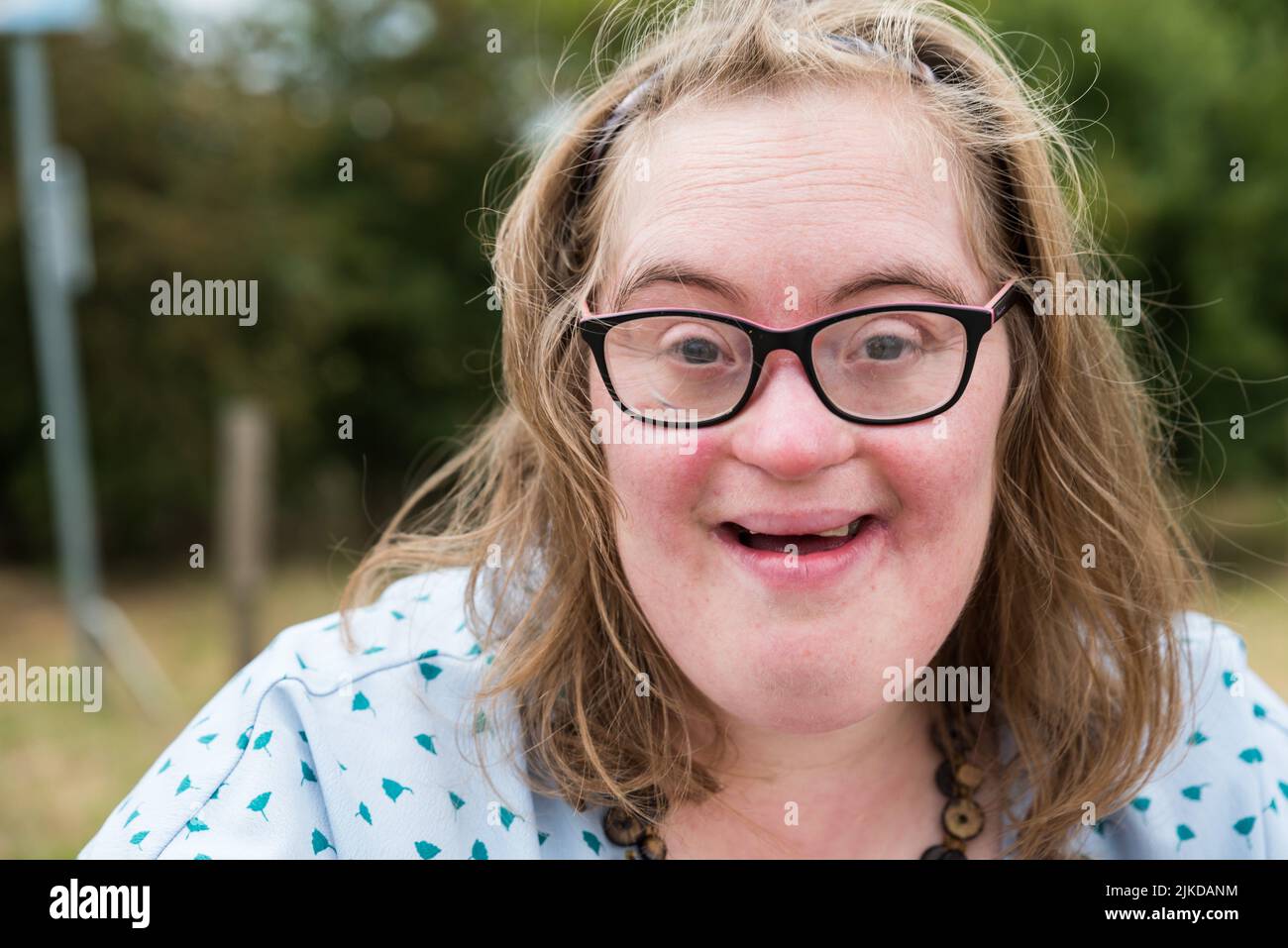 Girl down syndrome park hi-res stock photography and images - Alamy