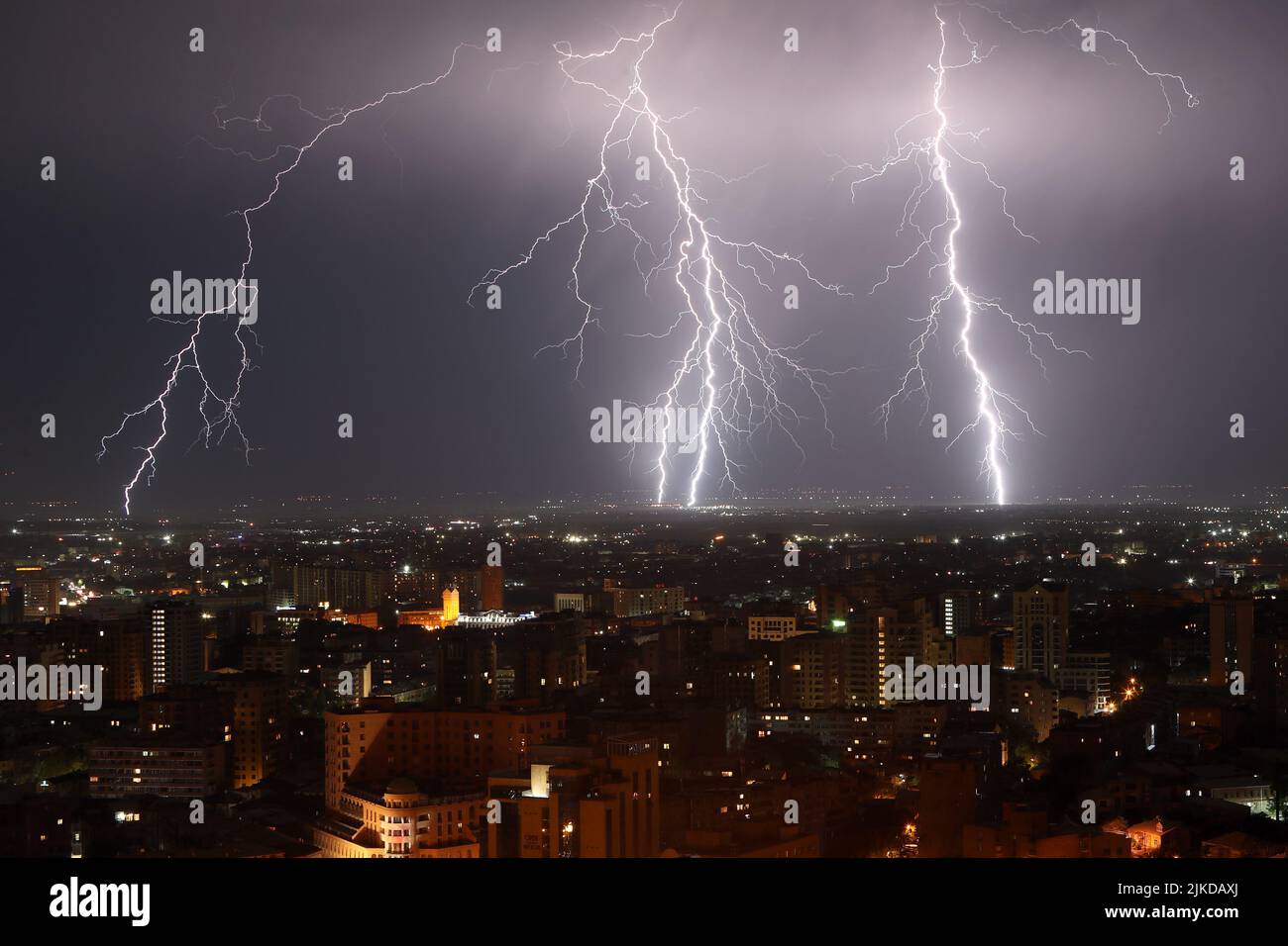 A beautiful shot of lightning striking over a city in a night sky Stock ...