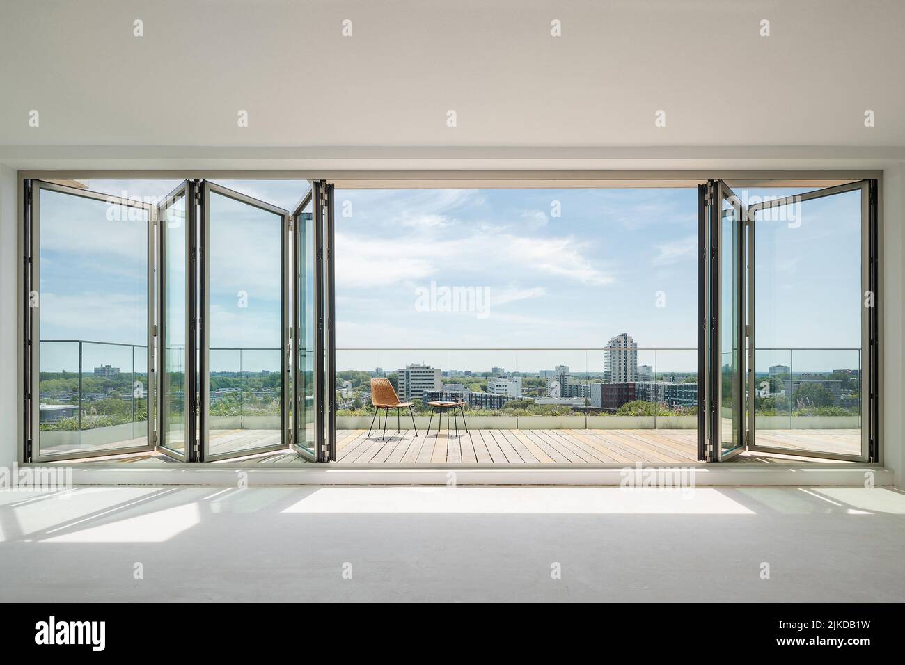 Open glass doors, terrace and city background Stock Photo - Alamy