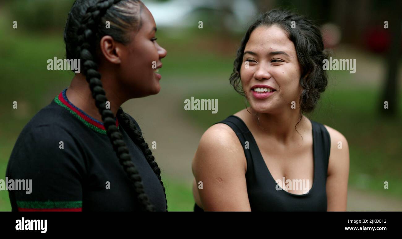 Two diverse friends laughing and smiling together. Mixed race ...