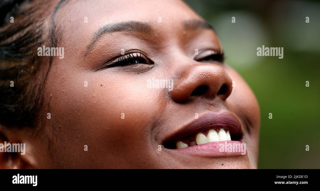 Thoughtful African woman closing and opening eyes to sky with HOPE and ...