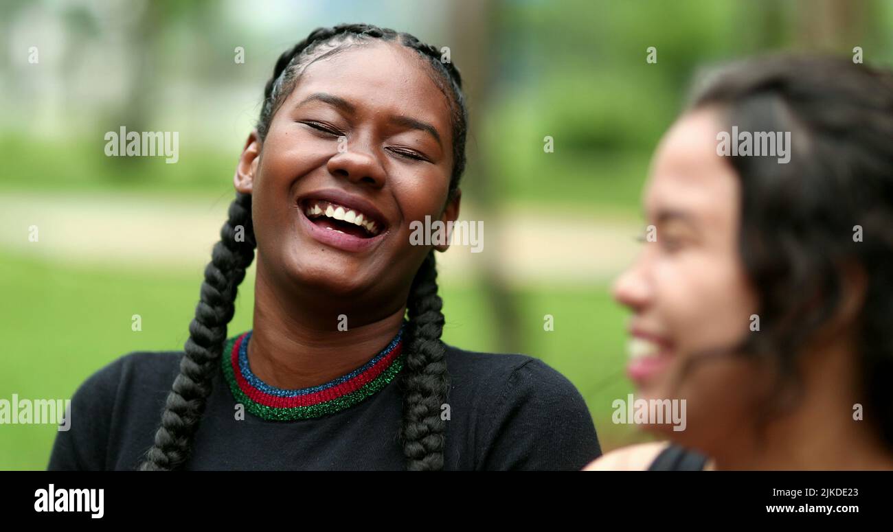 Two diverse friends laughing and smiling together. Mixed race ...