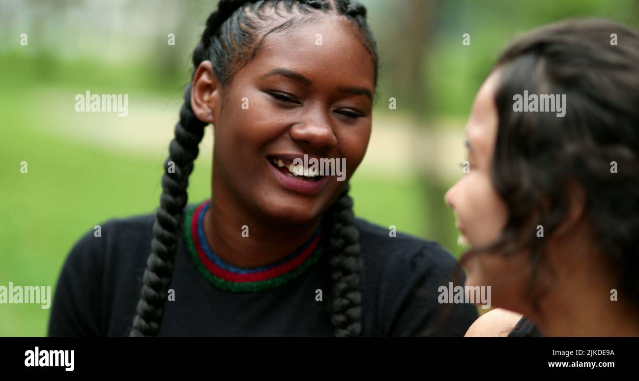 Two diverse friends laughing and smiling together. Mixed race ...
